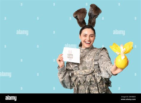 Happy Female Soldier In Bunny Ears With Greeting Card And Chocolate