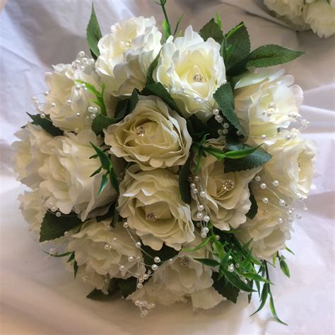 A Wedding Bouquet Collection Of Silk Ivory Roses With Diamante And Pearl