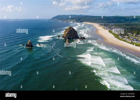 Aerial View Of Waves Crashing On Haystack Rock Along The Oregon Coast At Cannon Beach Stock