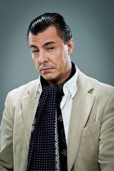 Sad Man With A Serious Expression Talking On A Cell Phone Drinking