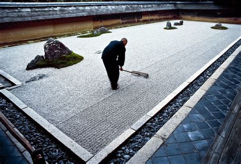 Zen Buddhist Monk Preparing Ryoanji Temple Garden In The Early Morning