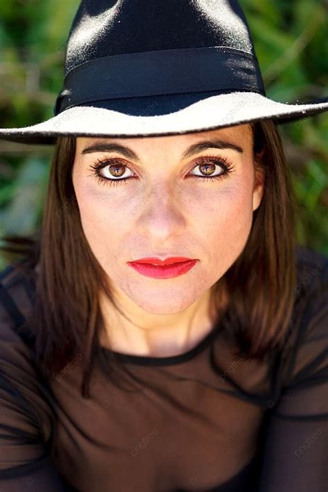 Attractive Mature Woman With Black Hat And Red Lips Outside Background