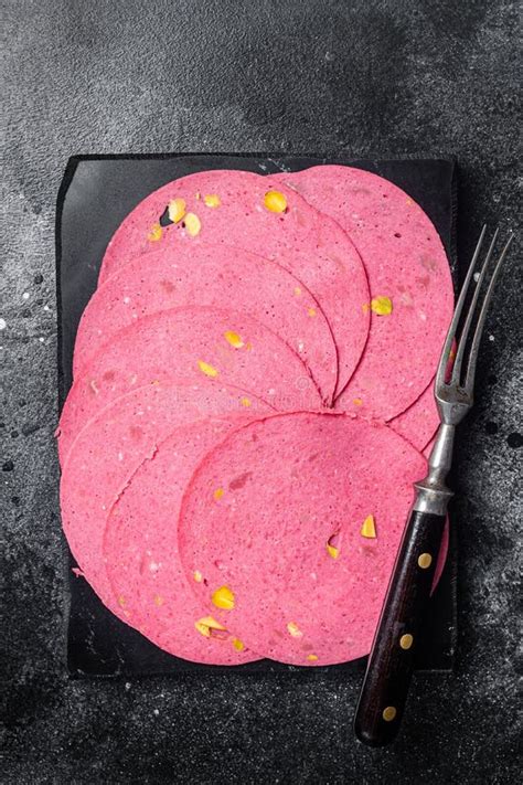 Slices Of Meat Salami Sausage With Pistachios Nuts On Marble Board