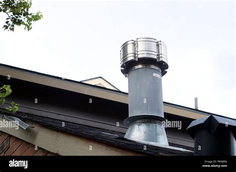 Exhaust Stack From A Gas Fired Water Boiler Mounted On Shingled Roof