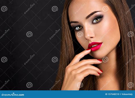Seductive Woman With Dark Brown Eye Makeup And Bright Red Lips And