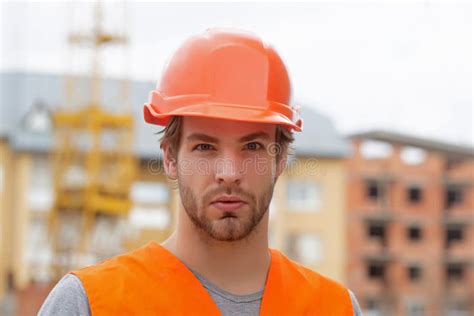 Construction Worker Man In Work Clothes And A Construction Helmet