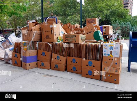 A Large Pile Of Discarded Cardboard Boxes Placed Curbside On A Street