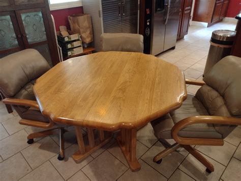 Solid Oak Octagonal Dining Table With Four Upholstered Rolling Chairs