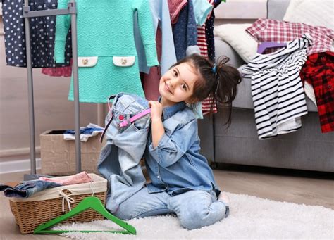 Niña En La Habitación Con Mucha Ropa Foto Premium