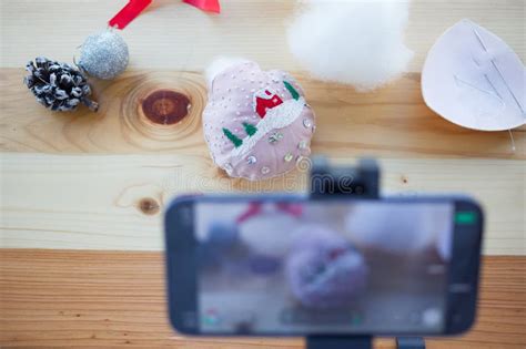 blurred smartphone screen with christmas diy objects on a table making xmas decor at home film