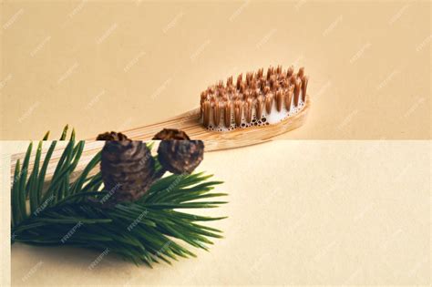 Premium Photo Toothbrush With Toothpaste Foam On A Background Of Pine Needles And Cones