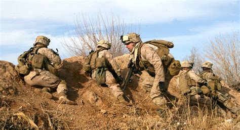 Hezbollah Fighters With A Pk Machine Gun And An M16 Rifle In A Foxhole