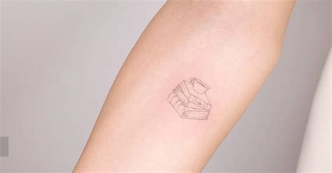 Books And Coffee Cup Tattoo Located On The Inner