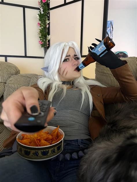 A Cosplayer Dressed As Silver From Deadlock Lounges On A Couch Sipping