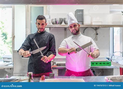 Two Male Chef Cooking Together In A Kitchen Stock Image Image Of
