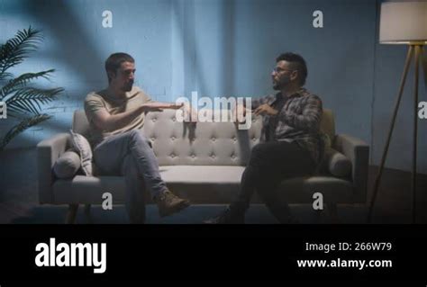 Two Men On A Couch Interview Scene Talking And Sharing Stories Podcast Concept High Quality
