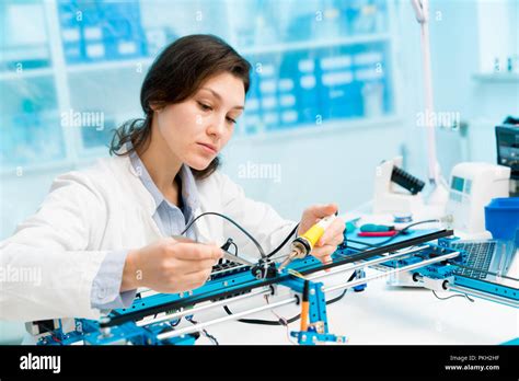 Babe Girl In Electronics Laboratory Experiment With Microcontroller And Robot Cnc Module
