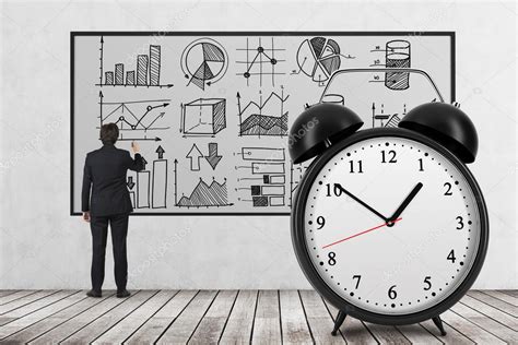 Rear View Of Businessman Who Is Drawing Analytical Charts On The