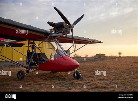 Ultralight Two Seater Airplane With A Propeller Stands On The Airfield