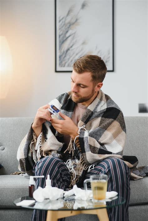 Close Up Of Oximeter On Hand Of Ill Person Resting While Measuring