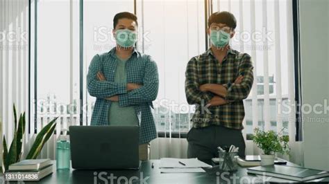 Asian Colleagues Are Standing With Arms Folded Expressing Confidence In