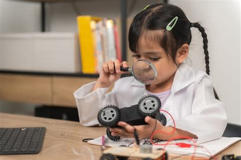 Premium Photo Asian Littlle Girl Constructing And Coding Robot At Stem Classfixing And Repair