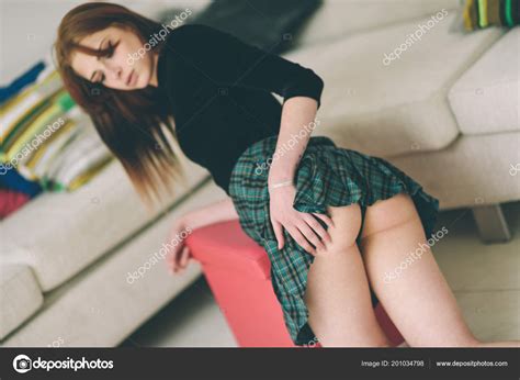 Young Sensual Woman Wearing Short Pleated Miniskirt Showing Her Panties