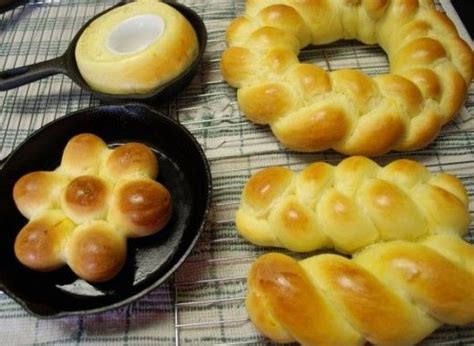 Some Breads Are Sitting On A Table And One Is In A Cast Iron Skillet