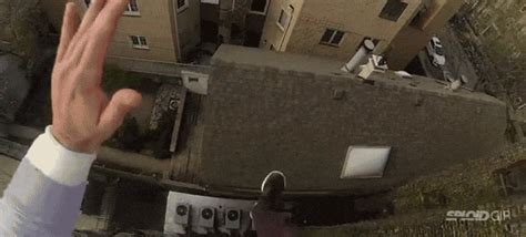 Guy Jumps Off A Building Slides Down A Roof And Lands On Stairs For