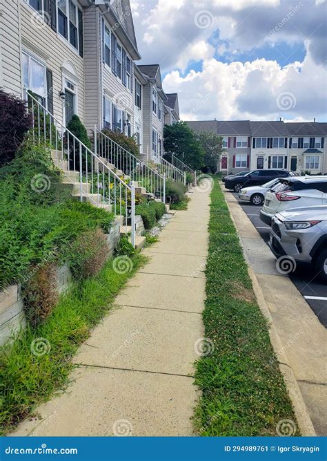 Quiet Street In A Residential Area In The Suburbs Rows Of Houses Along
