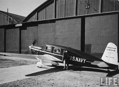 Caudron Simoun In Front Of Commercial Building