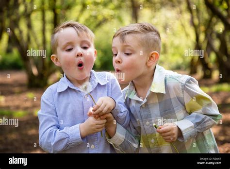 Two Brothers Together Outdoors In A Lifestyle Portrait With Natural