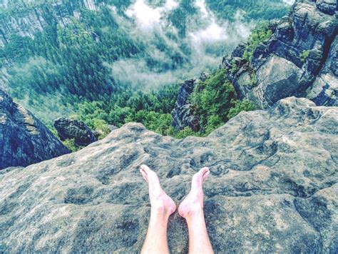 Naked Male Legs On Peak Make Step Sandstone Rock Above Valley With