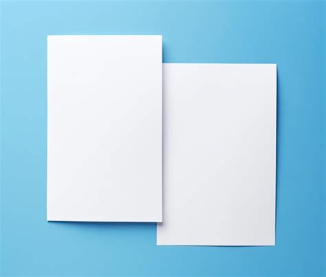 Premium Photo Two Blank Paper Sheets On A Blue Background