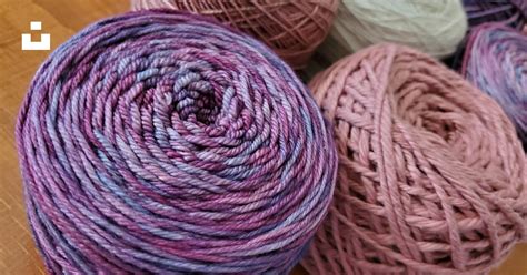 A Group Of Balls Of Yarn Sitting On Top Of A Wooden Floor Photo Free