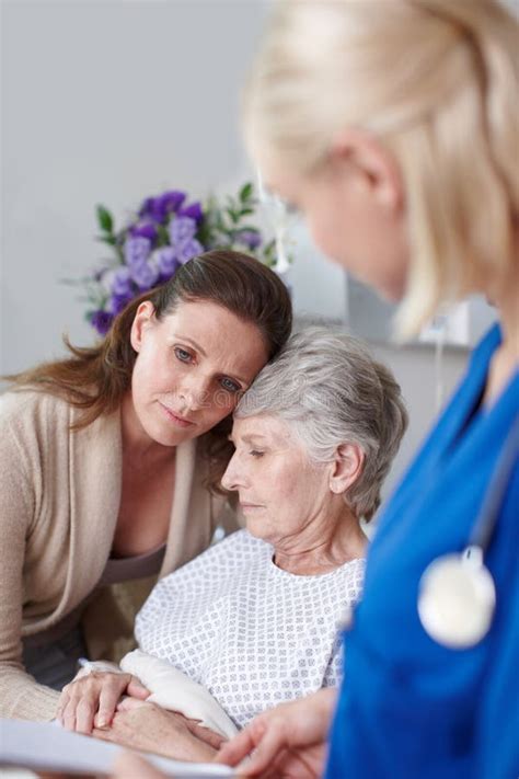 Elderly Mother Daughter And Nurse In Hospital For Medical Exam