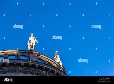 Sandstone Statues In Classicism Style At The Roof Of An Old Building At