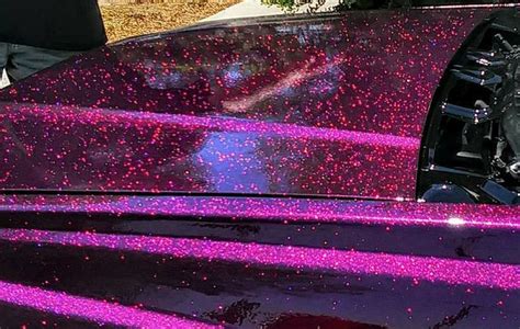A Purple Car With Pink Glitter On The Hood