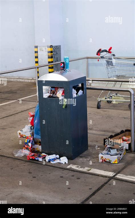 Overflowing Dumpster Trash Can With Plastic Bags And Cardboard Filthy Shopping Center