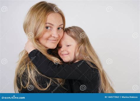 Cute Kind Caucasian Blonde Mom And Daughter Posing On White Background