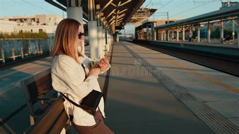 Young Woman Waiting Patiently At Railway Platform Checking Watch While