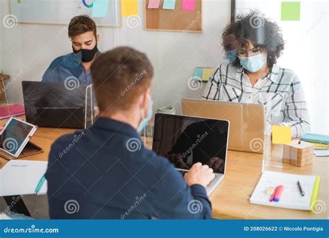 Young People Working Inside Modern Office Behind Plexiglas Focus