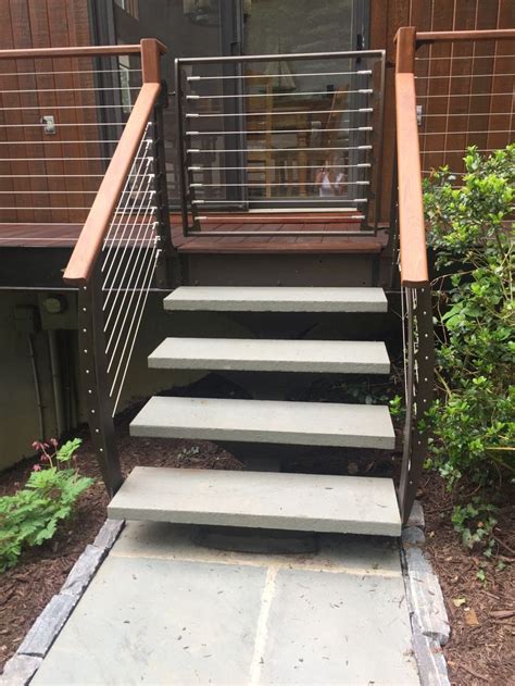 Floating Deck Stair With Mono Stringer Blue Stone Treads And Curved Cable Railings Garden