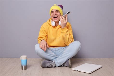 Portrait Of Cheerful Smiling Positive Man Wearing Beanie Hat Yellow