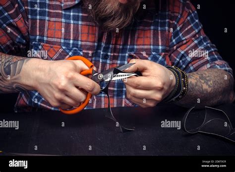 Currier Of Leather Demonstrates Leather Cutting Process In His Leather