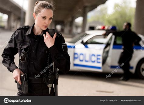 Young Attractive Policewoman Using Walkie Talkie Blurred Partner Car