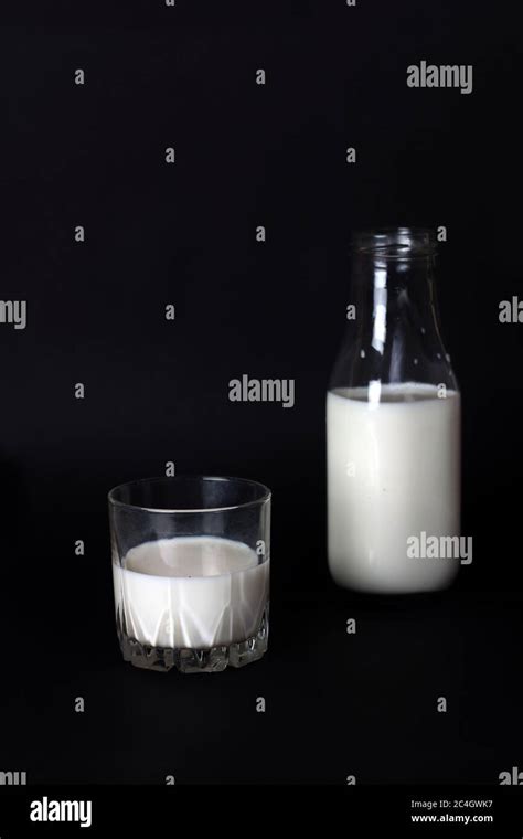 A Bottle And A Flass Of Milk Isolated On Black Background Image
