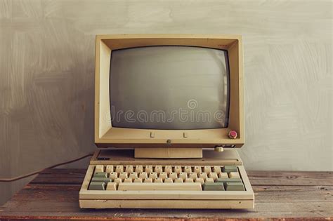 Vintage Computer With Monitor And Keyboard On Wooden Desk Stock