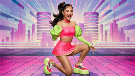 A Woman In A Pink And Green Outfit Is Dancing On A Dance Floor