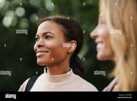 Multiracial Women Talking And Smiling After Yoga Practice In Summer